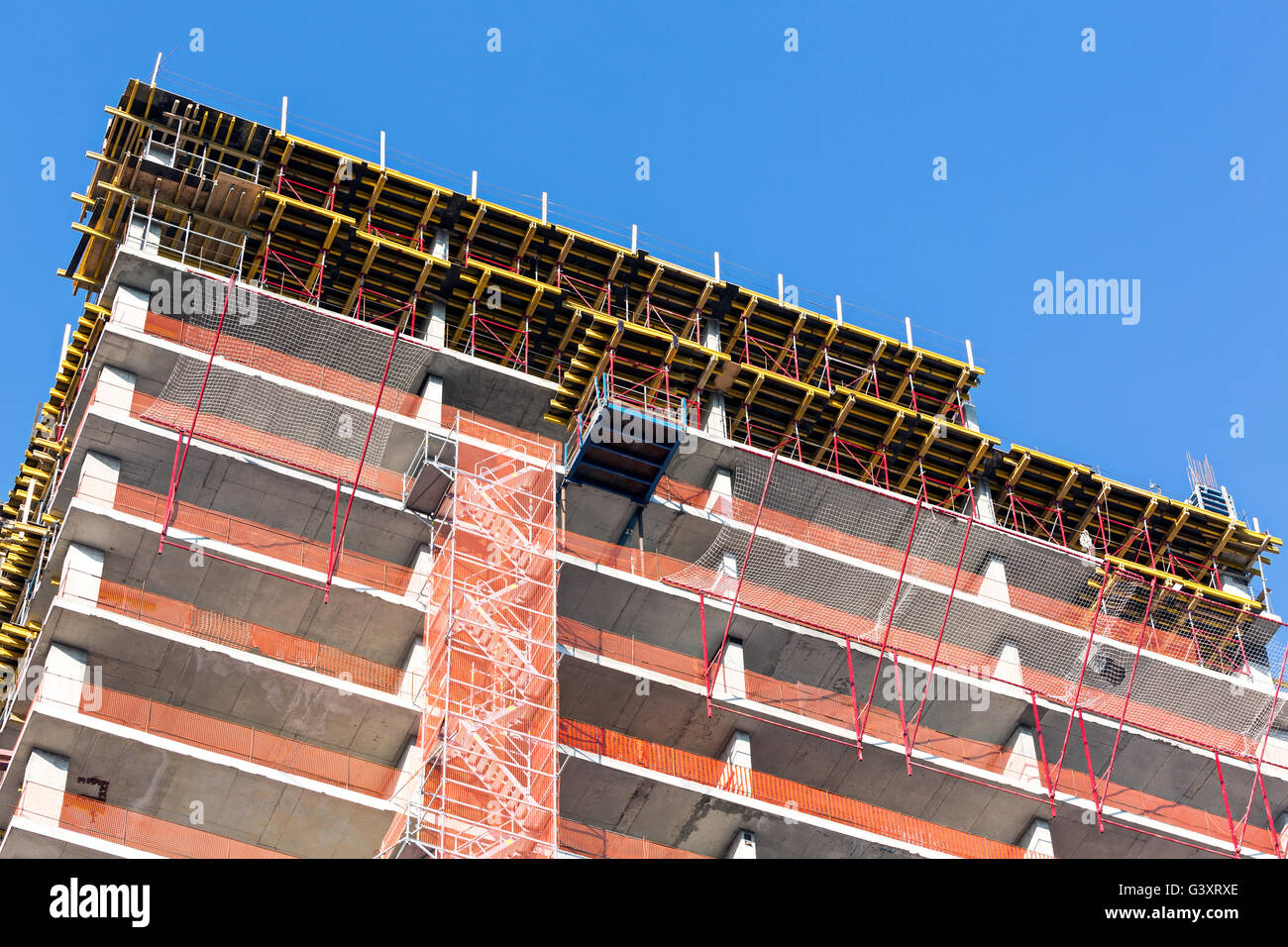 Multi-level commercial high-rise building construction with blue sky ...