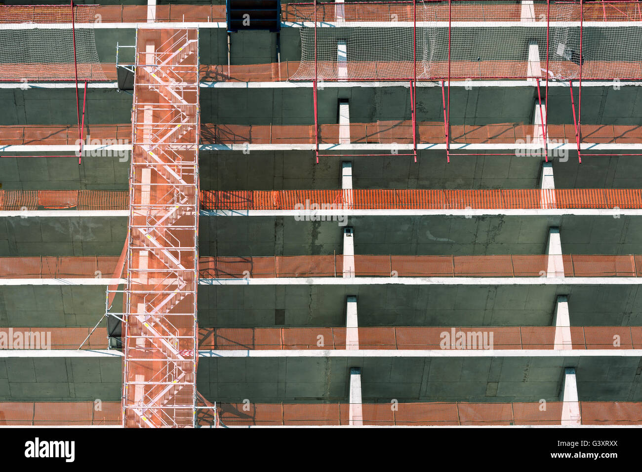Building facade under construction with red protective mesh Stock Photo ...