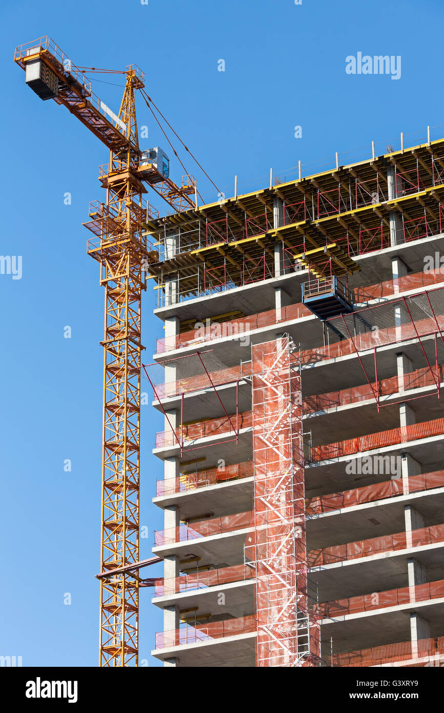 Concrete high-rise building under construction with tower crane Stock ...