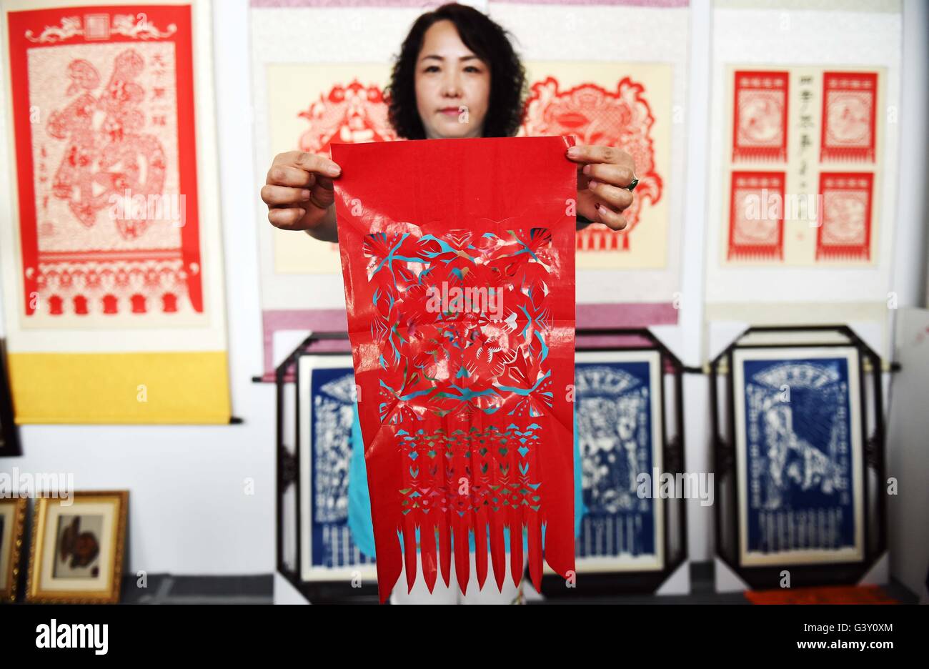 Harbin, China's Heilongjiang Province. 16th June, 2016. A woman shows a ...