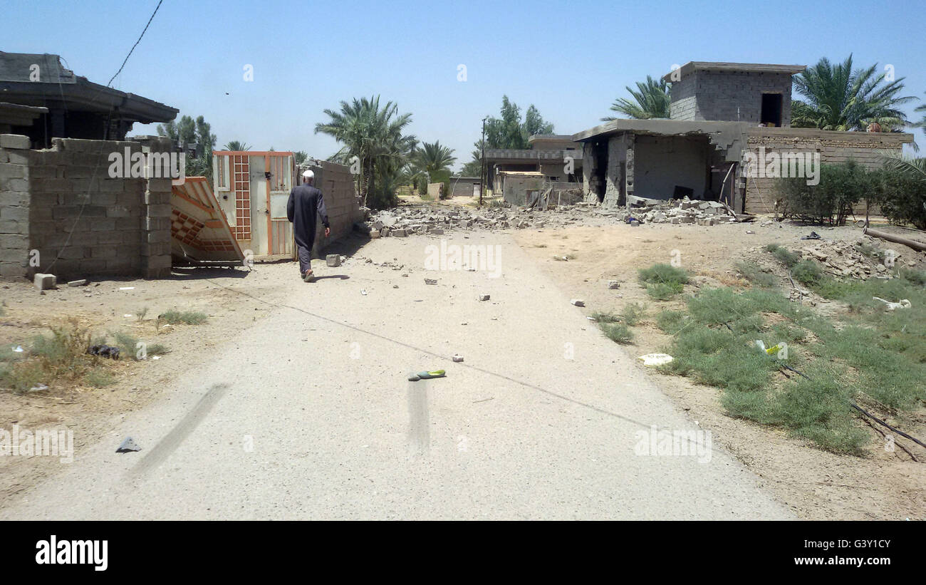 Fallujah, Iraq. 15th June, 2016. A man stands by a destroyed building ...