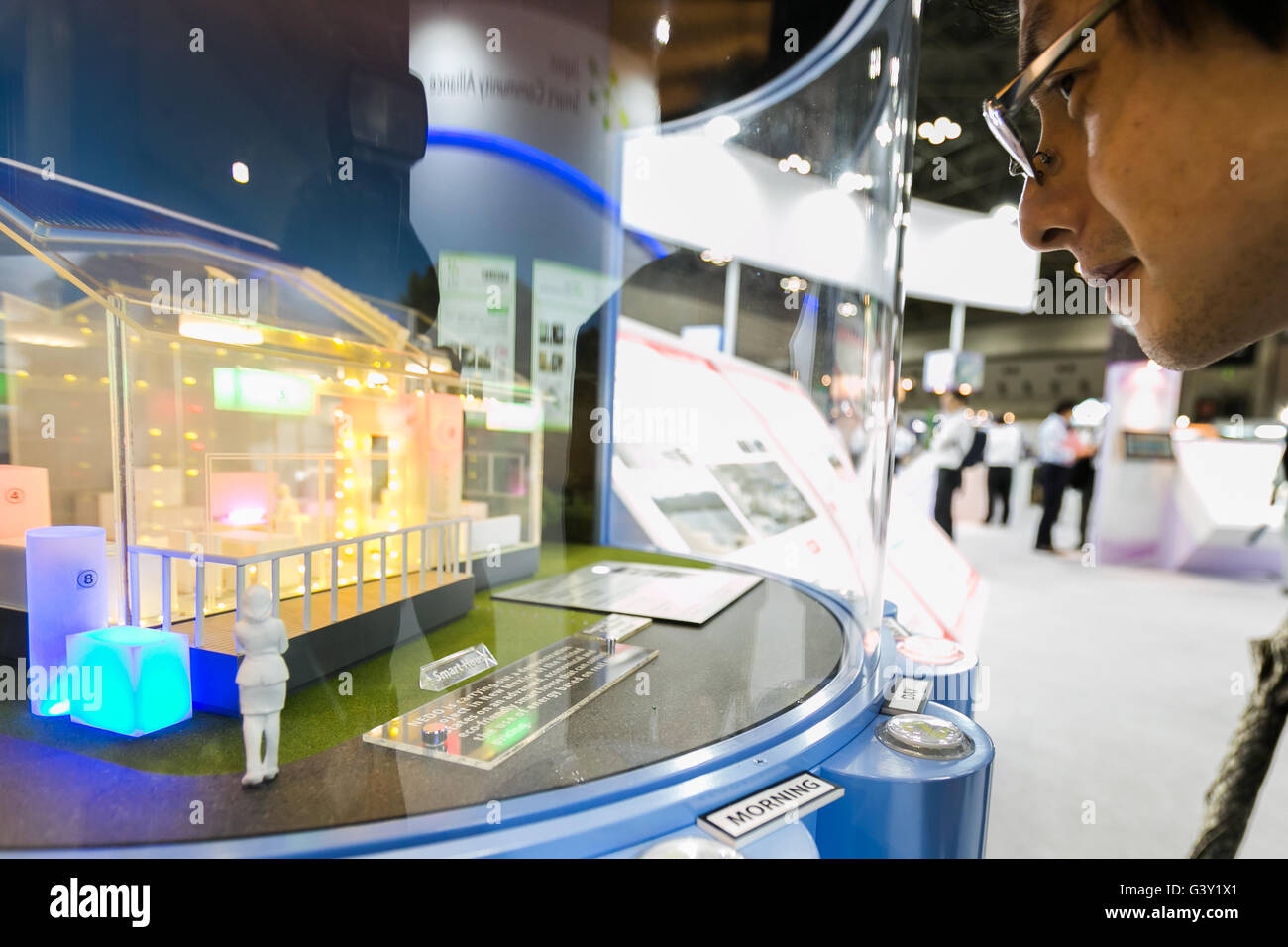 Tokyo, Japan. 16th June, 2016. A visitor looks at a scale model of a ...