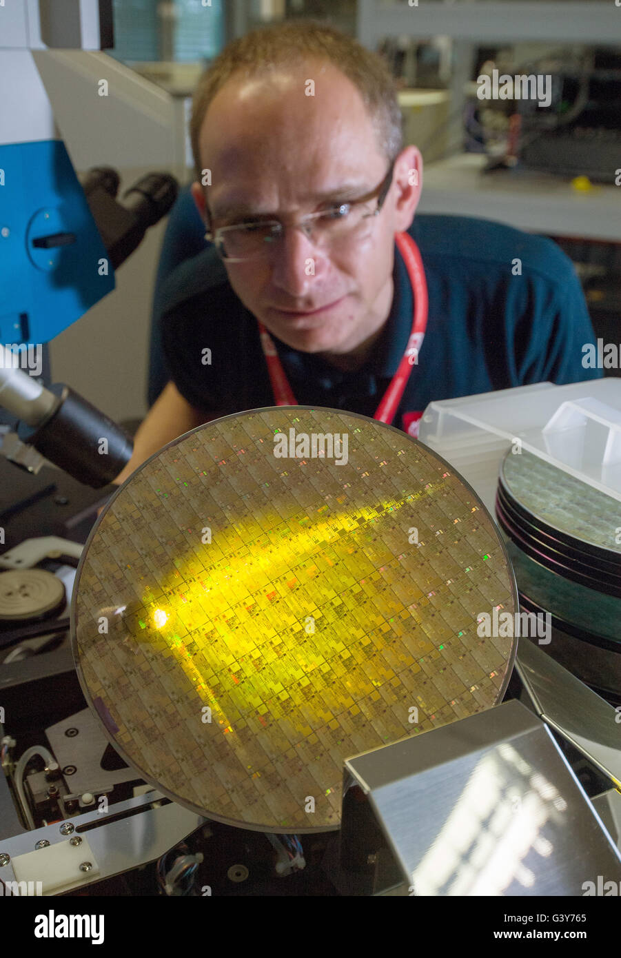 Falk Korndoerfer of the IHP holds up a waferupon which circuits (also ...