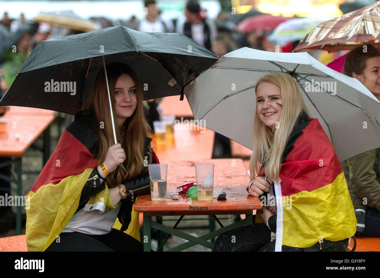 Freiburg, Germany. 16th June, 2016. Two German soccer fans watch the ...