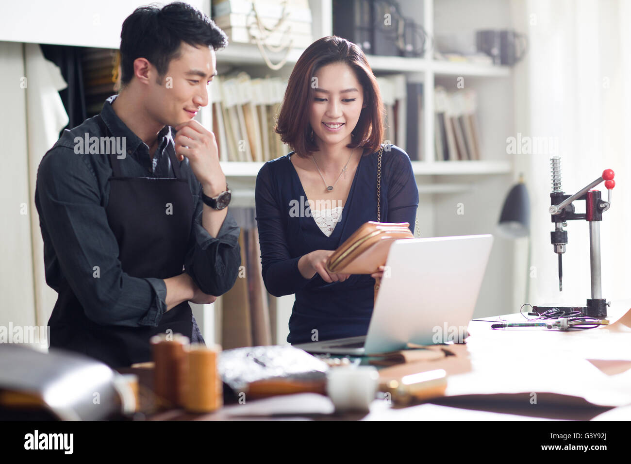 Craftsman and customer talking in studio Stock Photo - Alamy