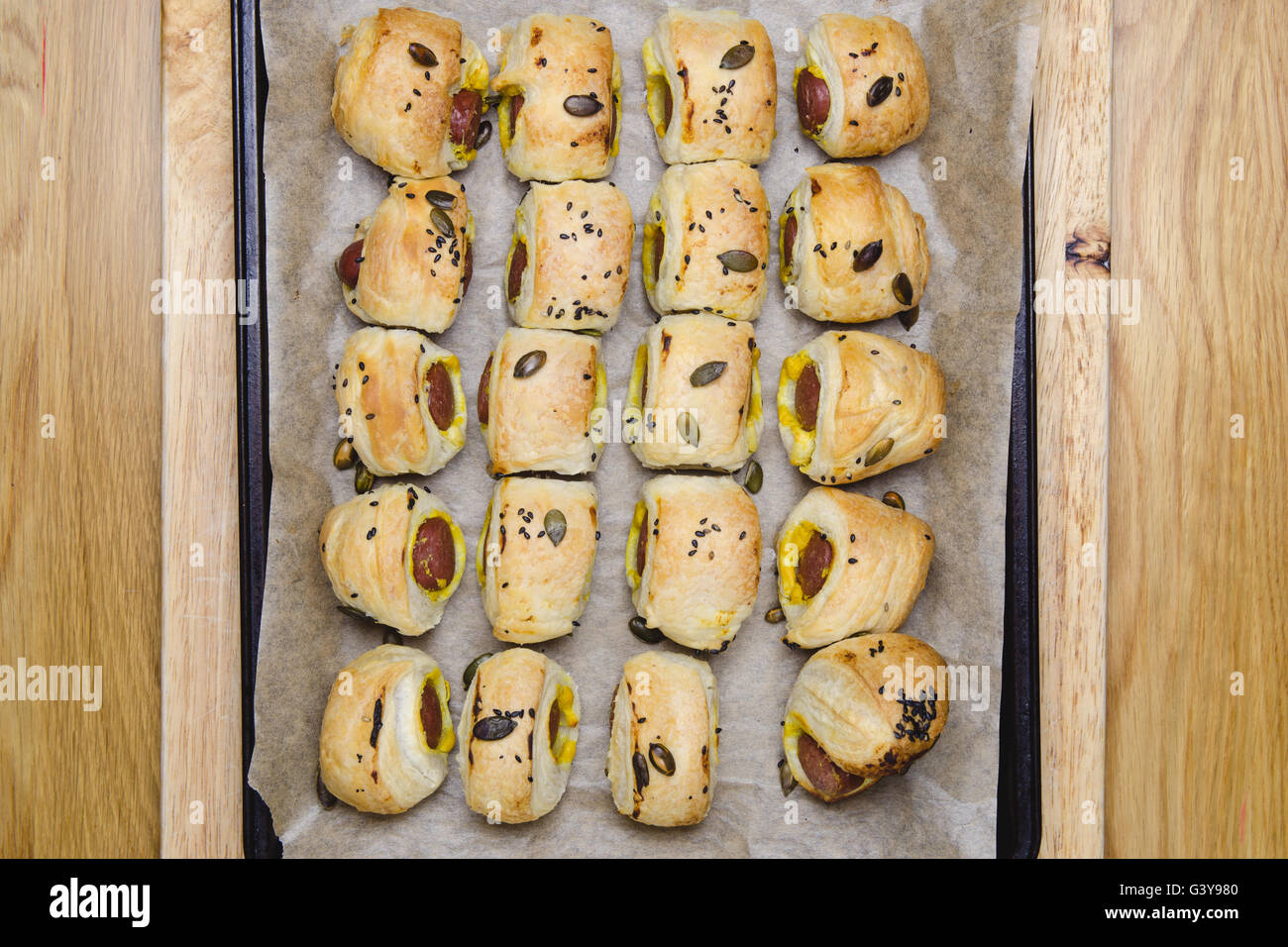 Baked sausages in a puff pastry - mini sausage rolls Stock Photo - Alamy