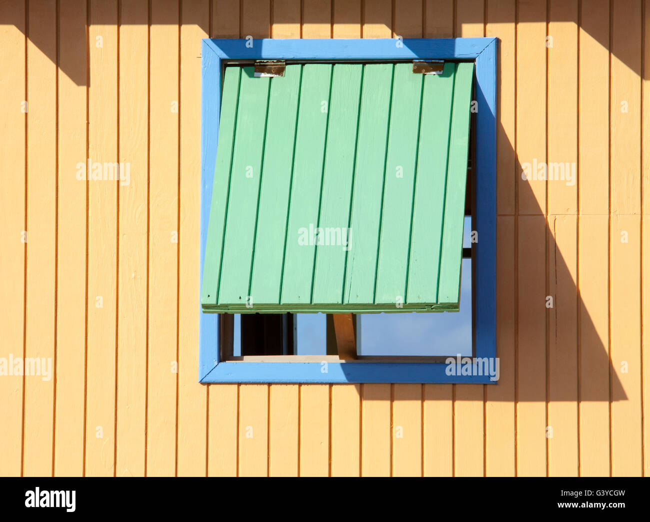 The colorful window of a wooden structure built on Half Moon Cay beach ...