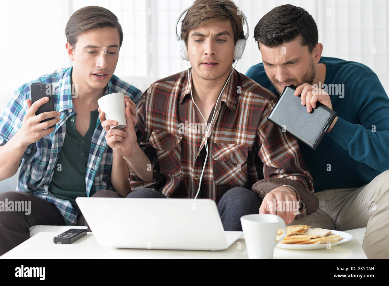 men watching video on laptop Stock Photo - Alamy