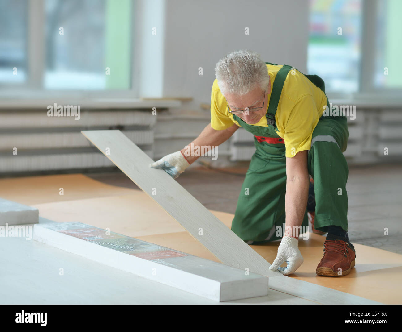 Senior man repairing in the room Stock Photo - Alamy