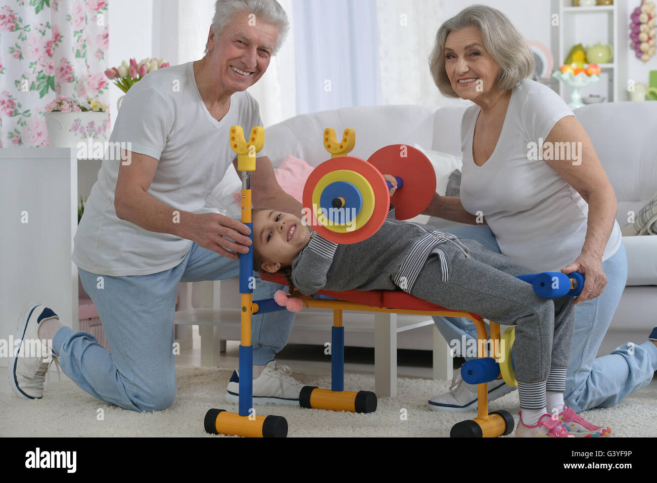 parents and granddaughter doing exercise Stock Photo - Alamy