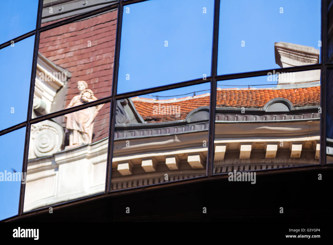 reflection of stone facade on modern glass facade Stock Photo - Alamy
