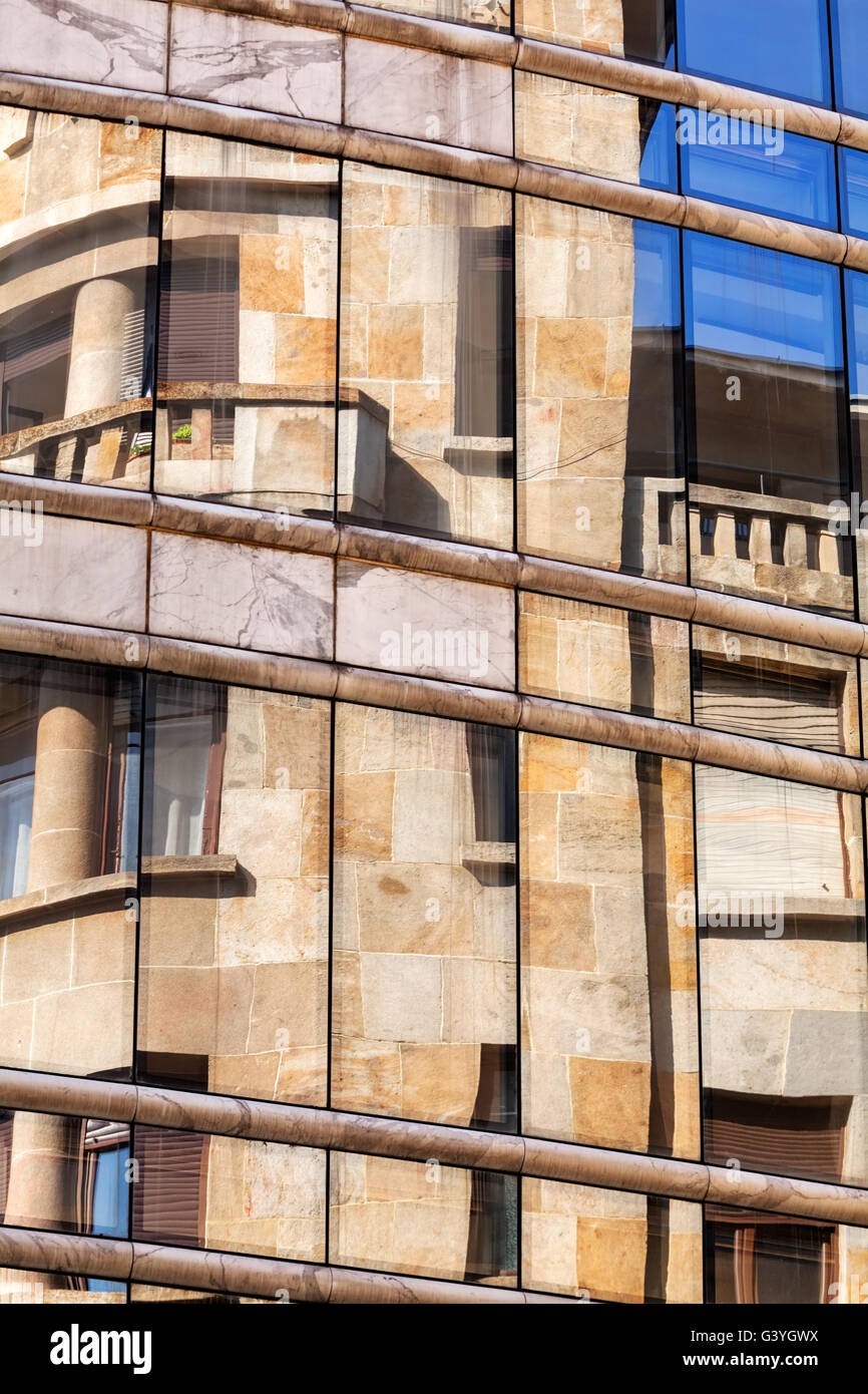 reflection of stone facade on modern glass facade Stock Photo - Alamy