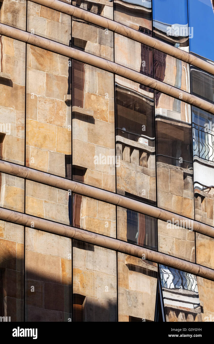 reflection of stone facade on modern glass facade Stock Photo - Alamy
