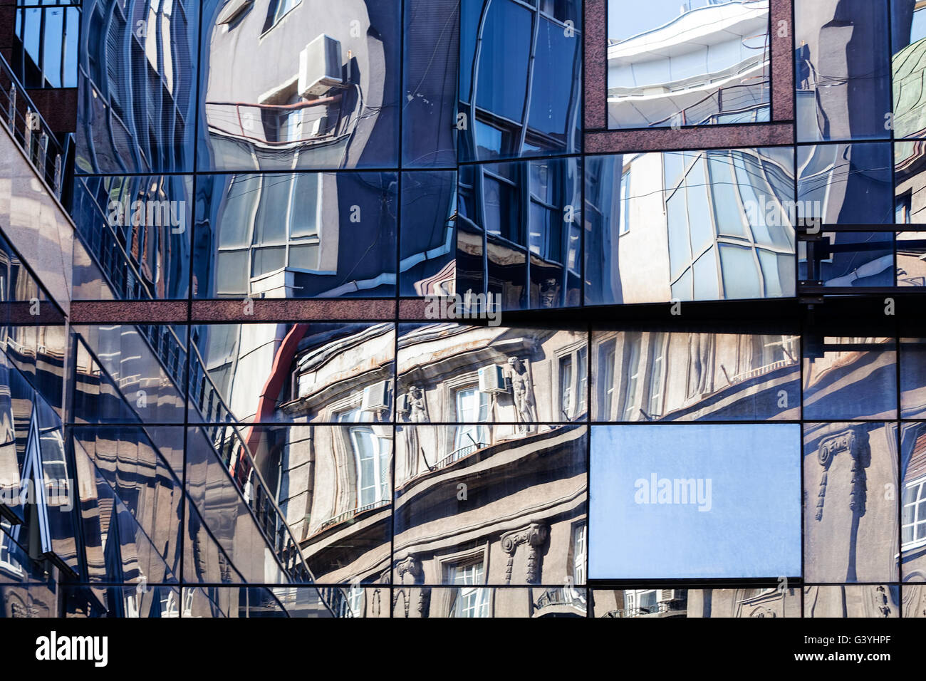 reflection of stone facade on modern glass facade Stock Photo - Alamy