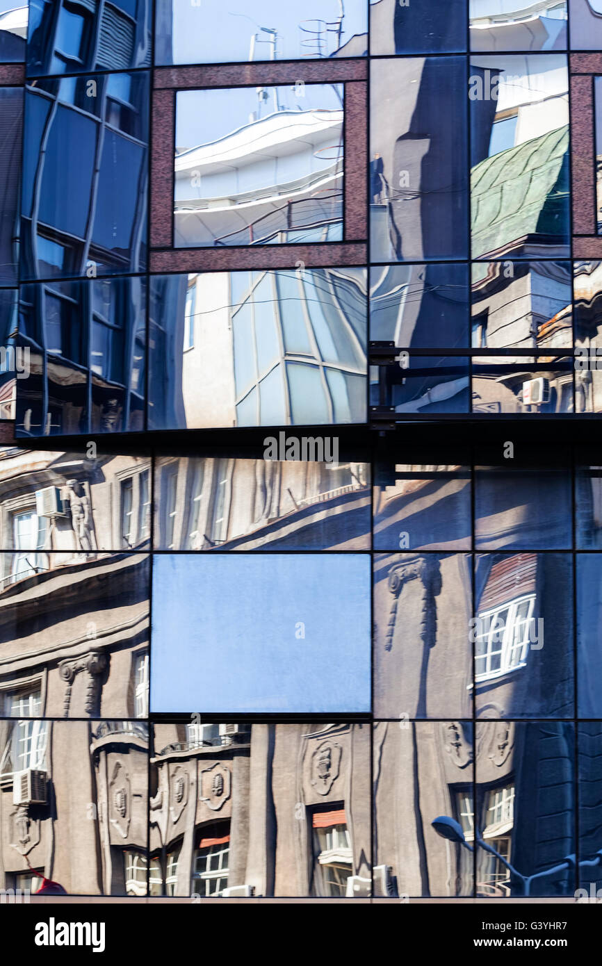 reflection of stone facade on modern glass facade Stock Photo - Alamy