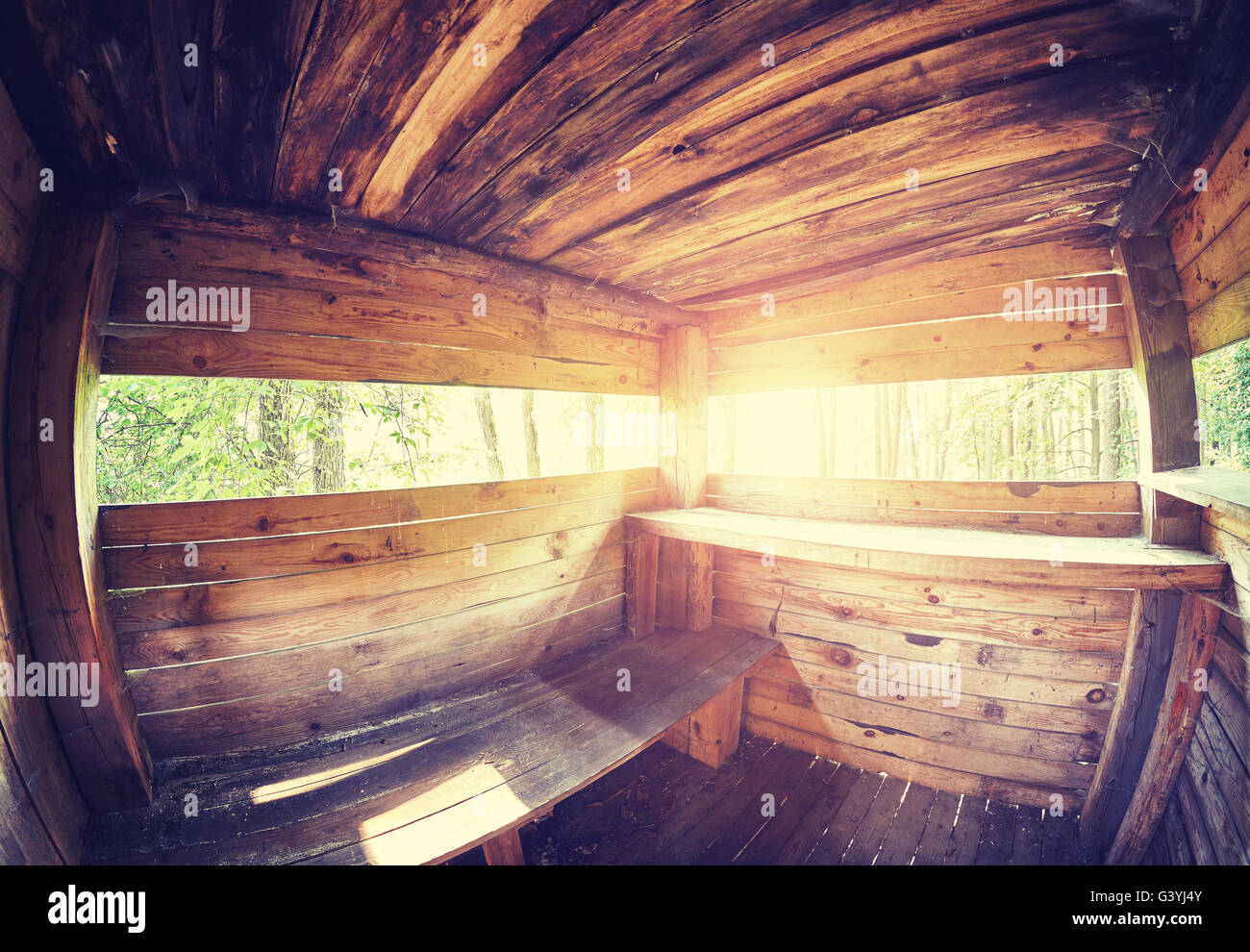 Vintage toned fisheye lens photo of hunting tower interior at sunset ...