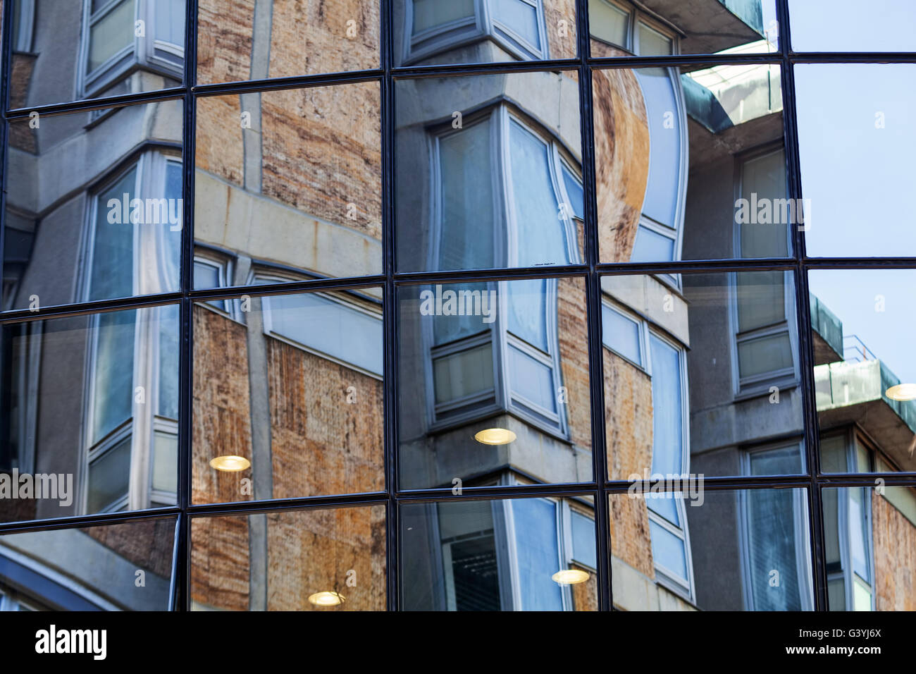 reflection of stone facade on modern glass facade Stock Photo - Alamy