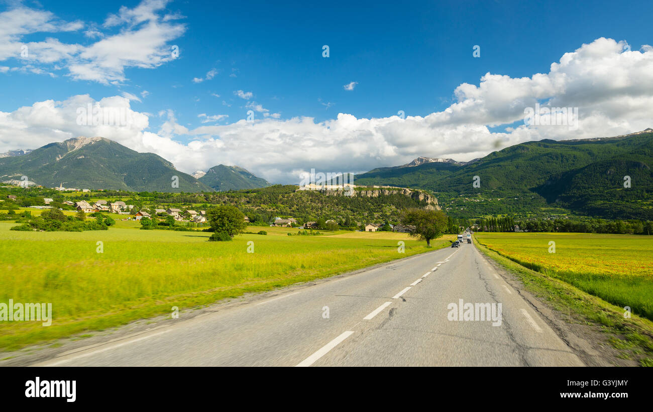 Paved two lane road crossing mountains and forest in scenic alpine ...