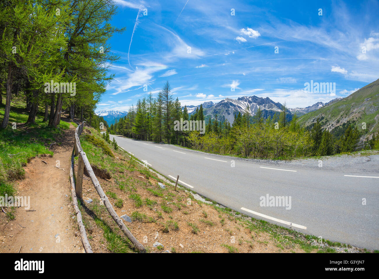 Paved two lane road crossing mountains and forest in scenic alpine ...