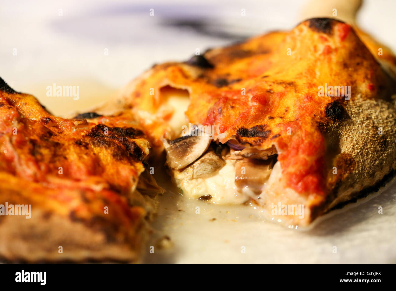 Italian calzone pizza in a dish Stock Photo - Alamy