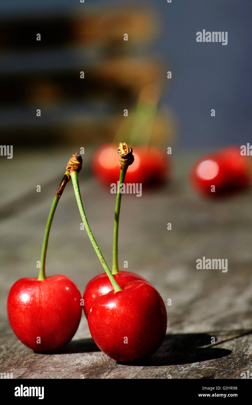 fresh cherries on wooden table Stock Photo - Alamy