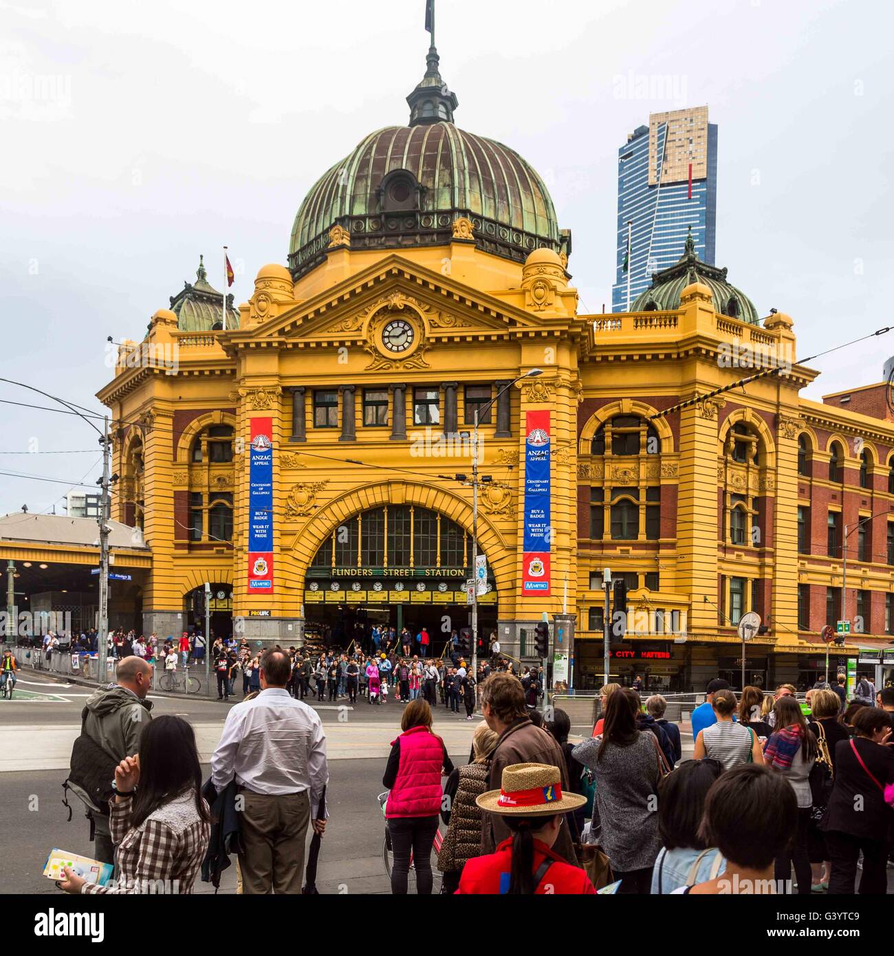 A crowd of shoppers and tourists in front of Flinders Street Station ...