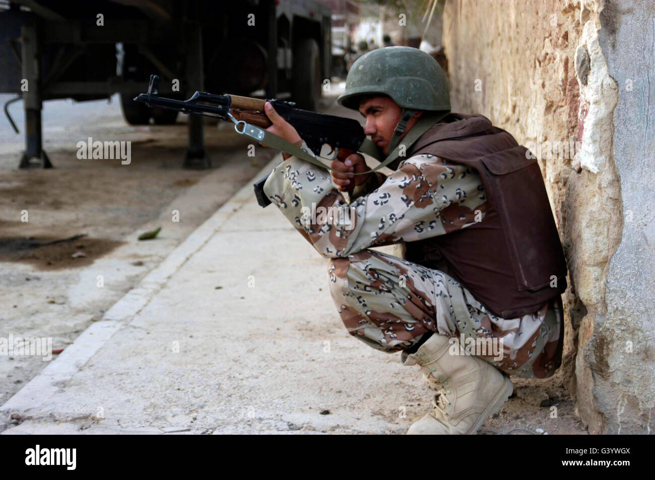 Member of the Iraqi Security Forces provides security for his comrades ...