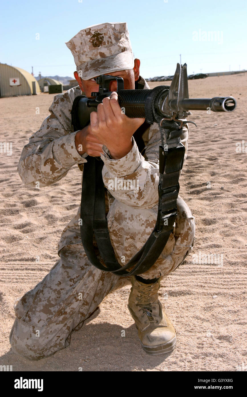 A Marine takes a knee Stock Photo - Alamy