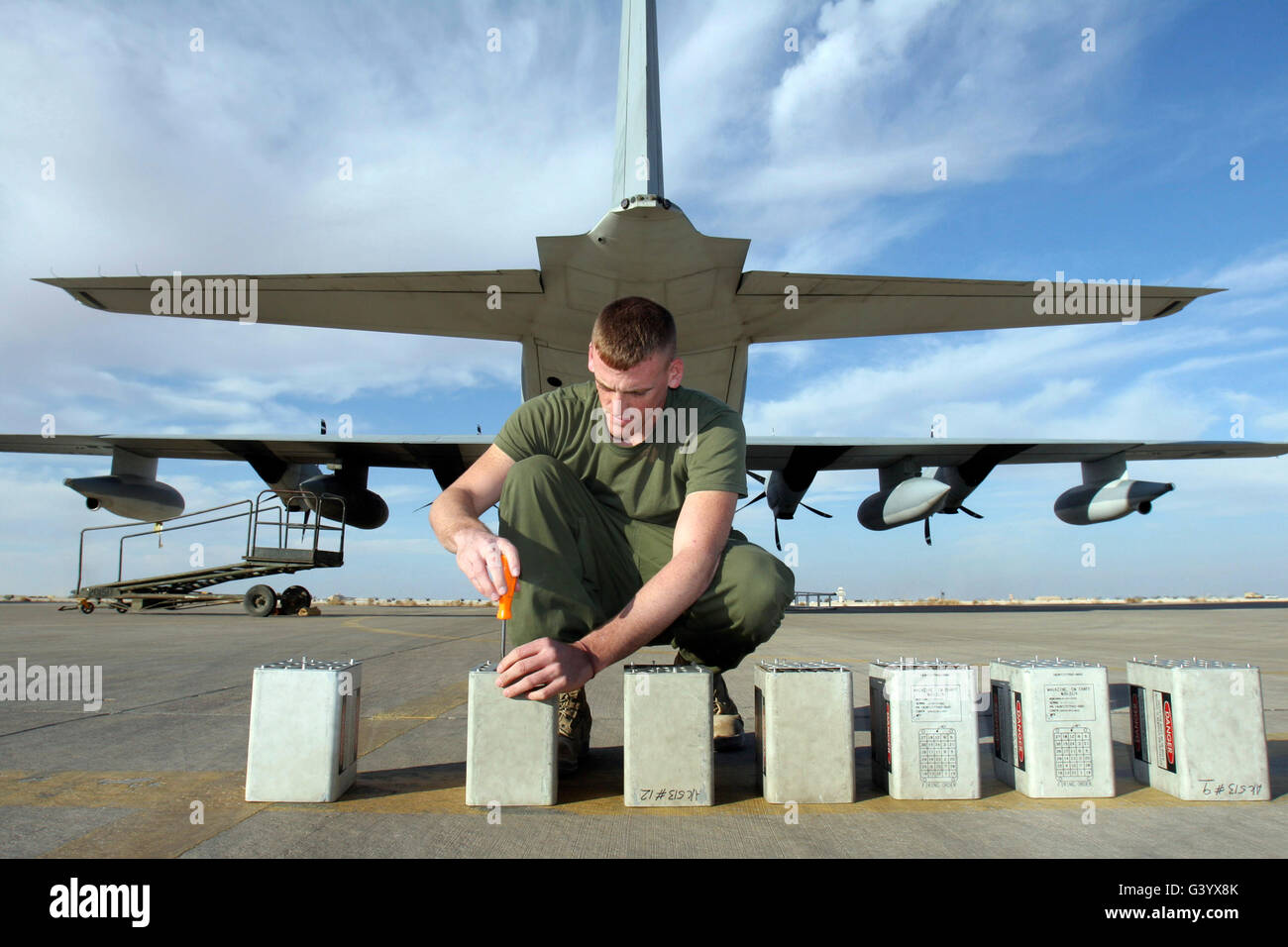 A marine replaces flares in flare dispensers from a KC-130J Hercules ...