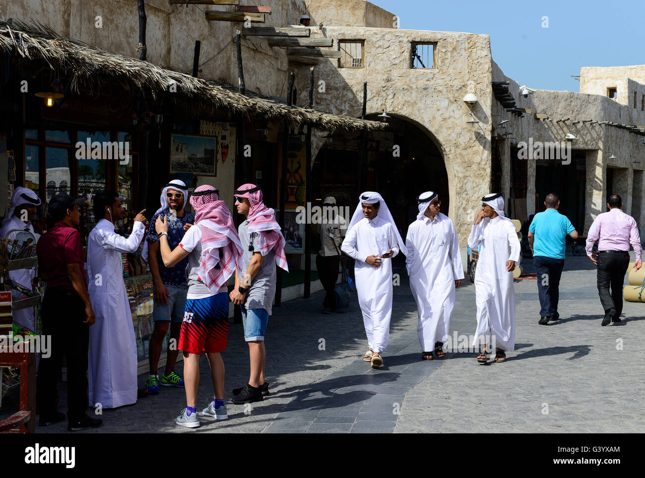 QATAR, Doha, Bazar Souq Waqif , western tourist with arab headgear ...