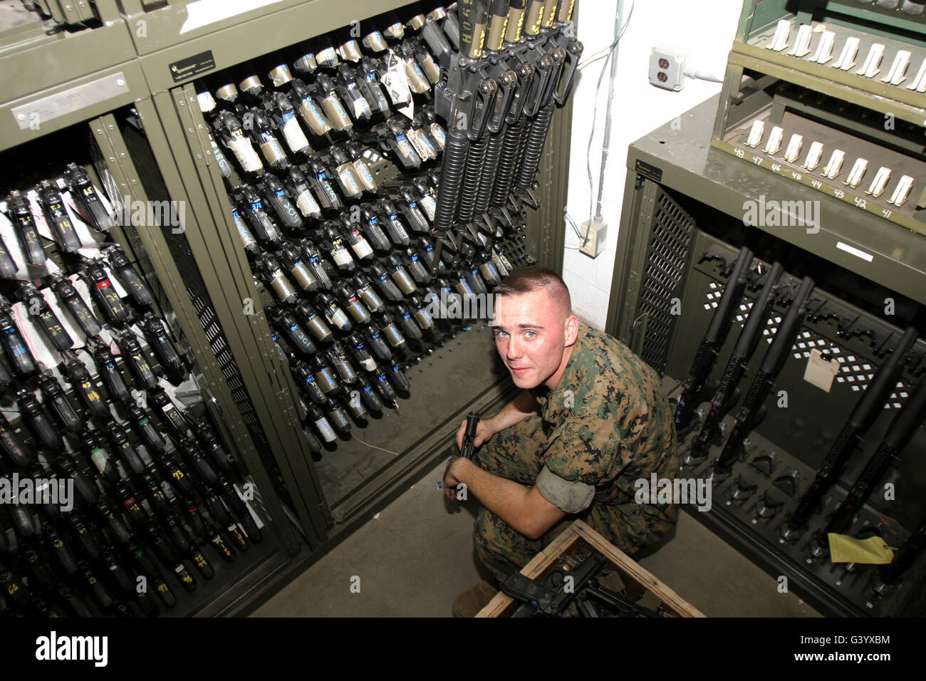 Small arms repair technician conducts a sight count of the weapons in ...