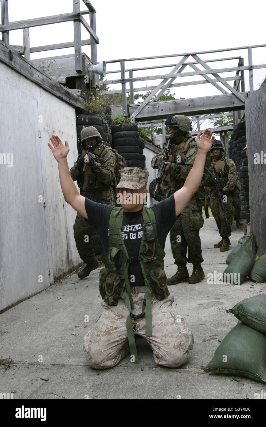 A soldier surrenders to Marines during a raid Stock Photo - Alamy