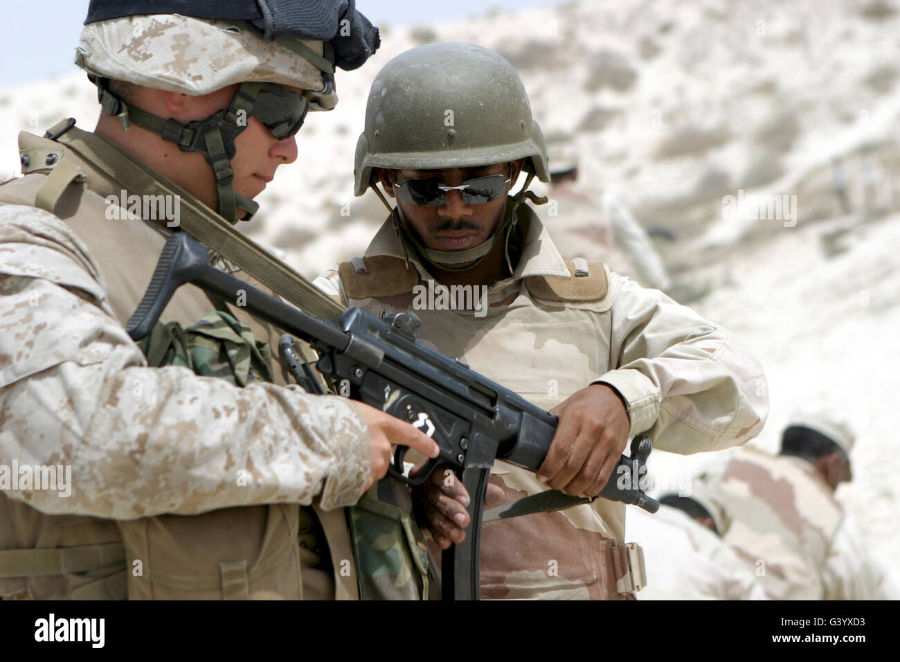 A machine gunner is coached on how to load an MP5 submachine gun Stock ...