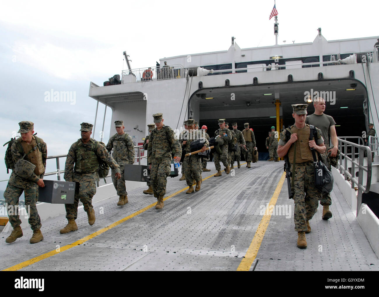 Marines and sailors descend the loading ramp of the WestPac Express ...