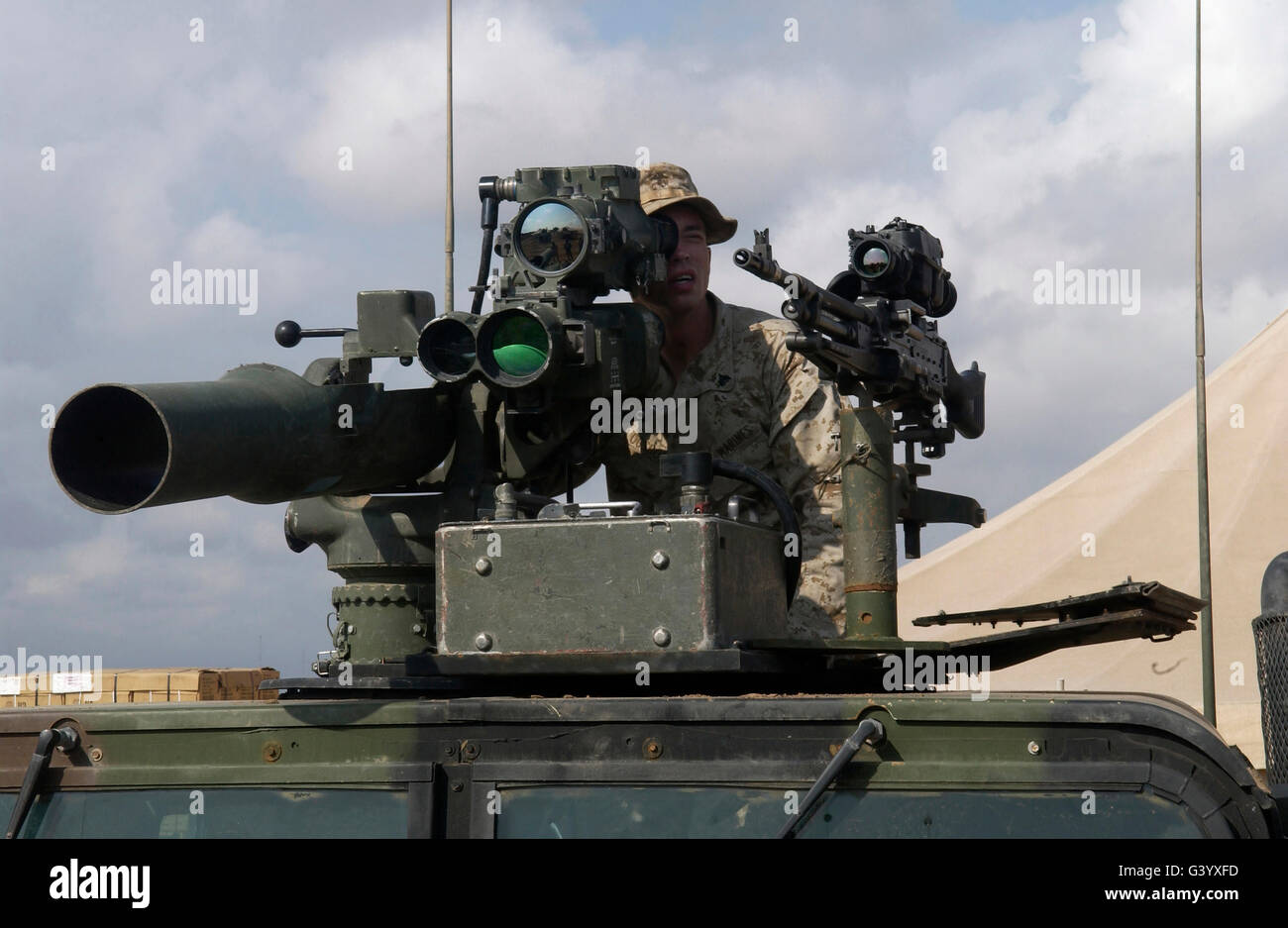 U.S Marine looks through a sight on a Tow Missile mounted on top of a ...