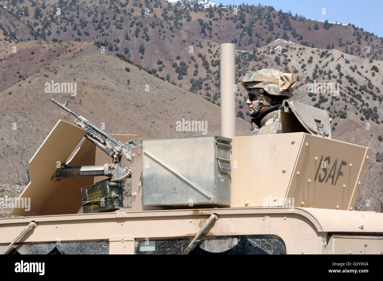 U.S. Army Specialist scans his sector while his convoy stops for a ...