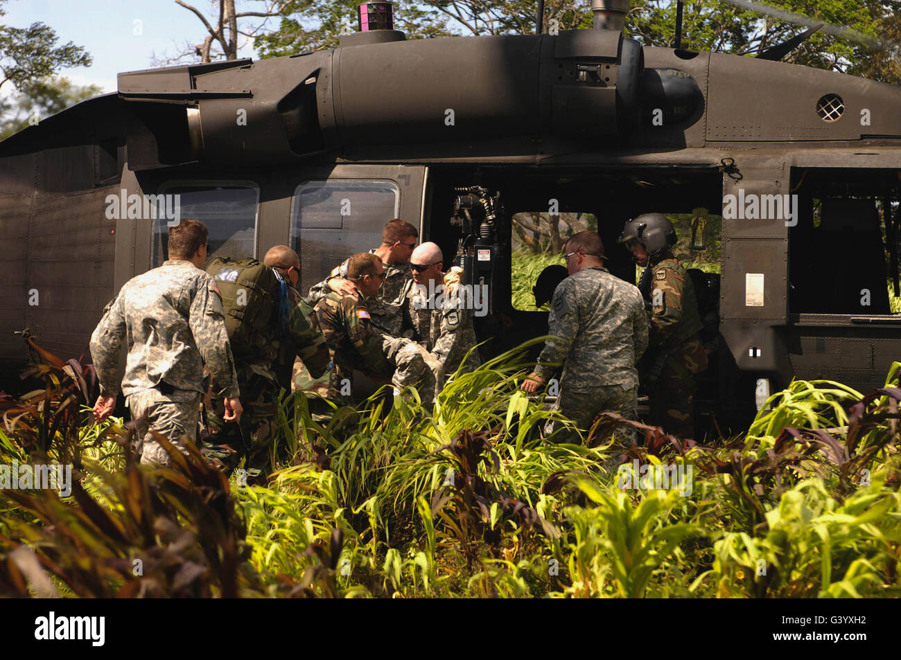 U.S. Army Soldiers load a patient onto a UH-60 Black Hawk helicopter ...