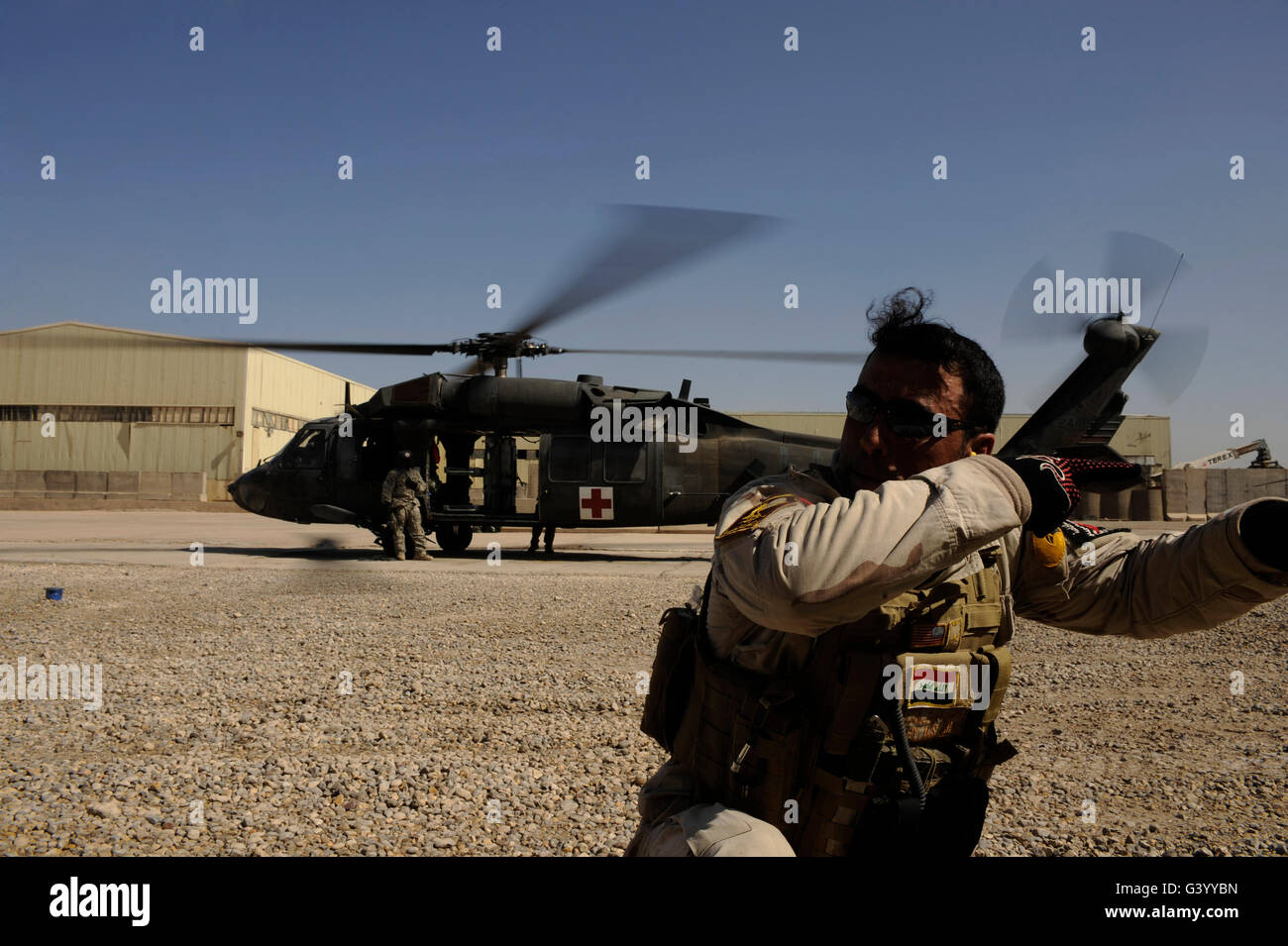 A soldier provides security after exiting a UH-60 Blackhawk helicopter ...