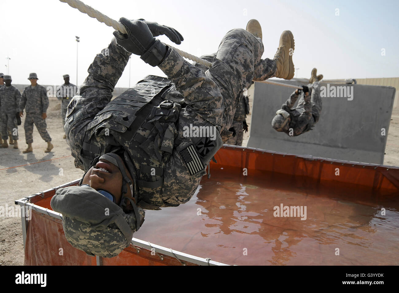 Army Specialist uses a 15 foot rope to cross a water obstacle Stock ...