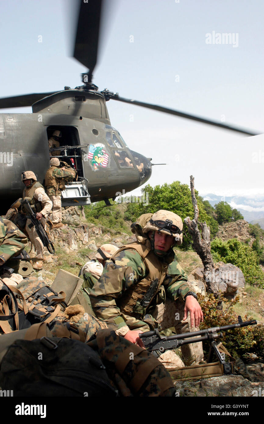 U.S. Marines providing security as fellow Marines exit a CH-46 Chinook ...
