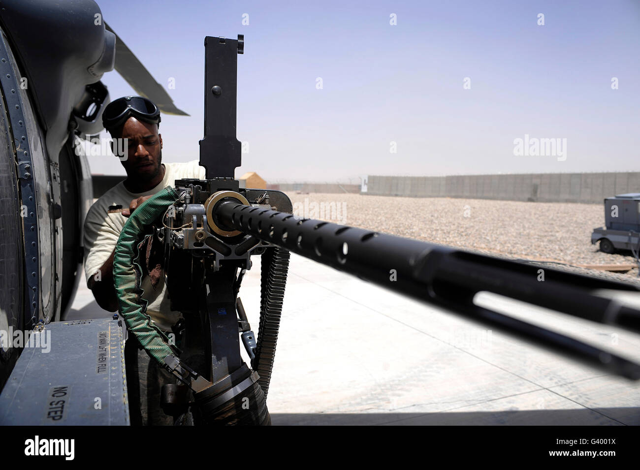 U.S. Air Force Airman performing routine maintenance on the .50 caliber ...