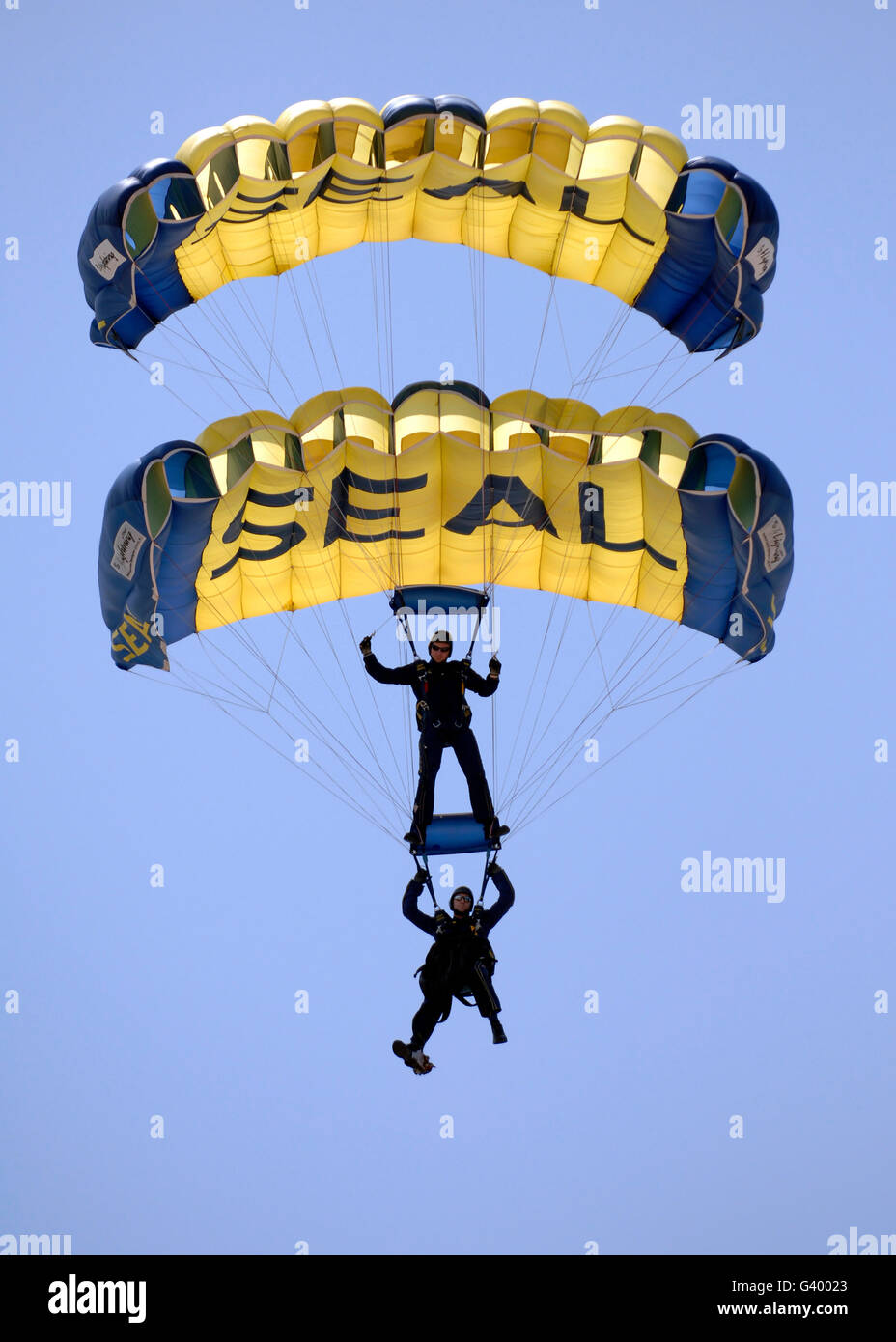 Members of the U.S. Navy Parachute Team, the Leap Frogs, flare their ...