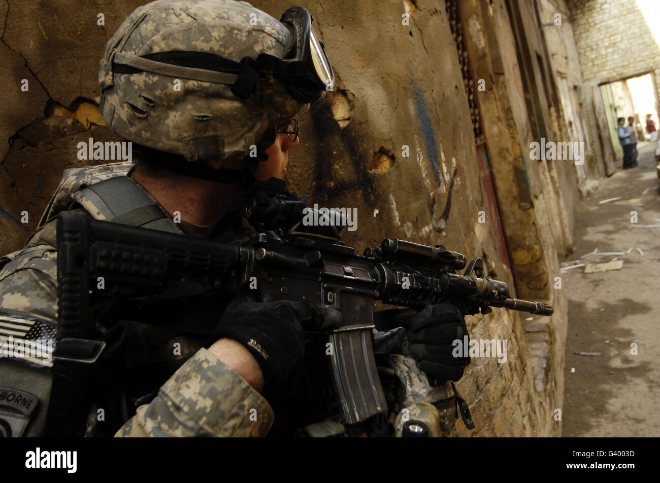 A U.S. Army soldier providing security while his platoon searches a ...