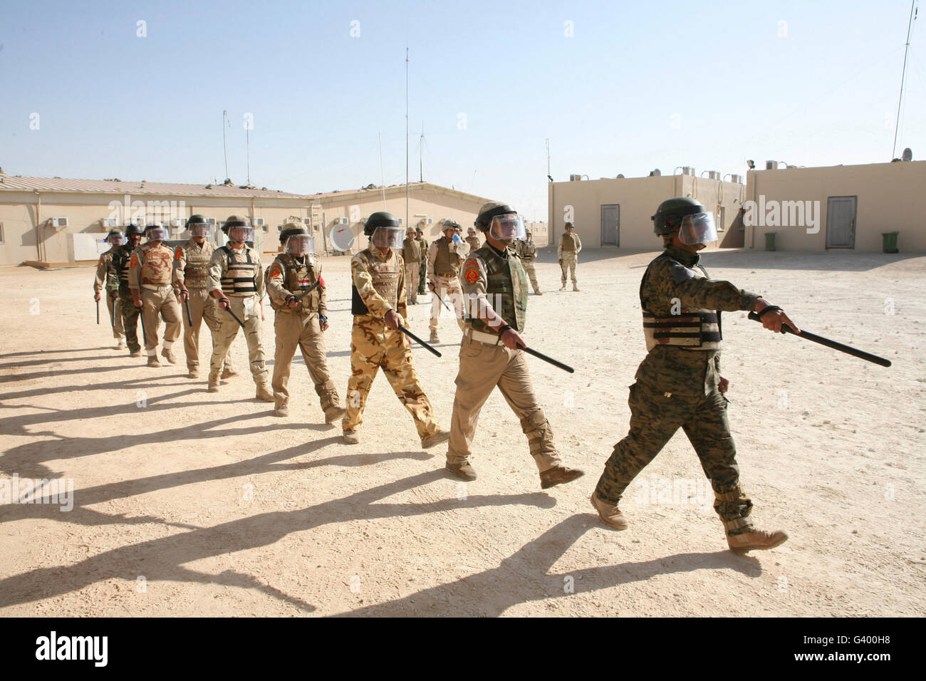 Iraqi Army soldiers march into formation during a riot control training ...