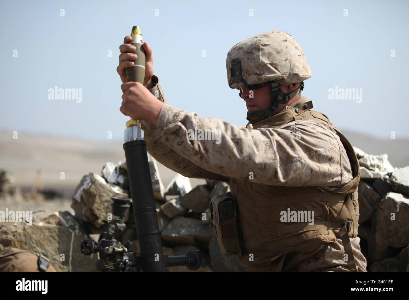 A U.S. Marine loads a mortar into a mortar tube Stock Photo - Alamy