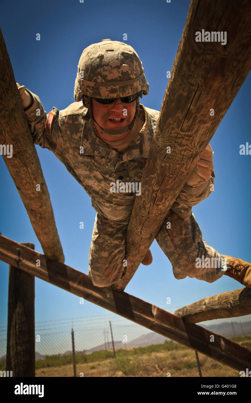 U.S. Army soldier climbs over an obstacle at a confidence course at ...