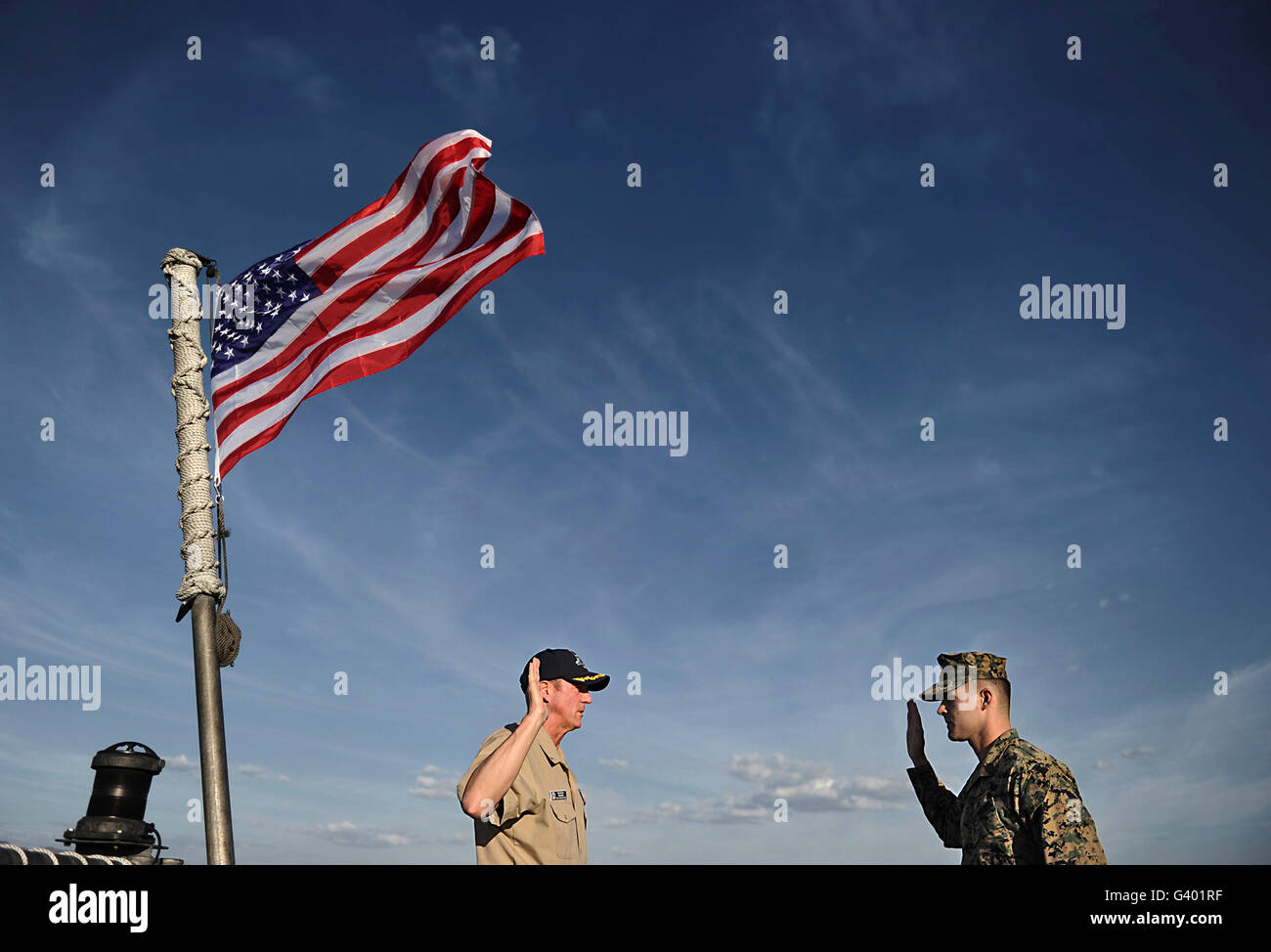 A commander administers the oath of enlistment to a Staff Sergeant ...
