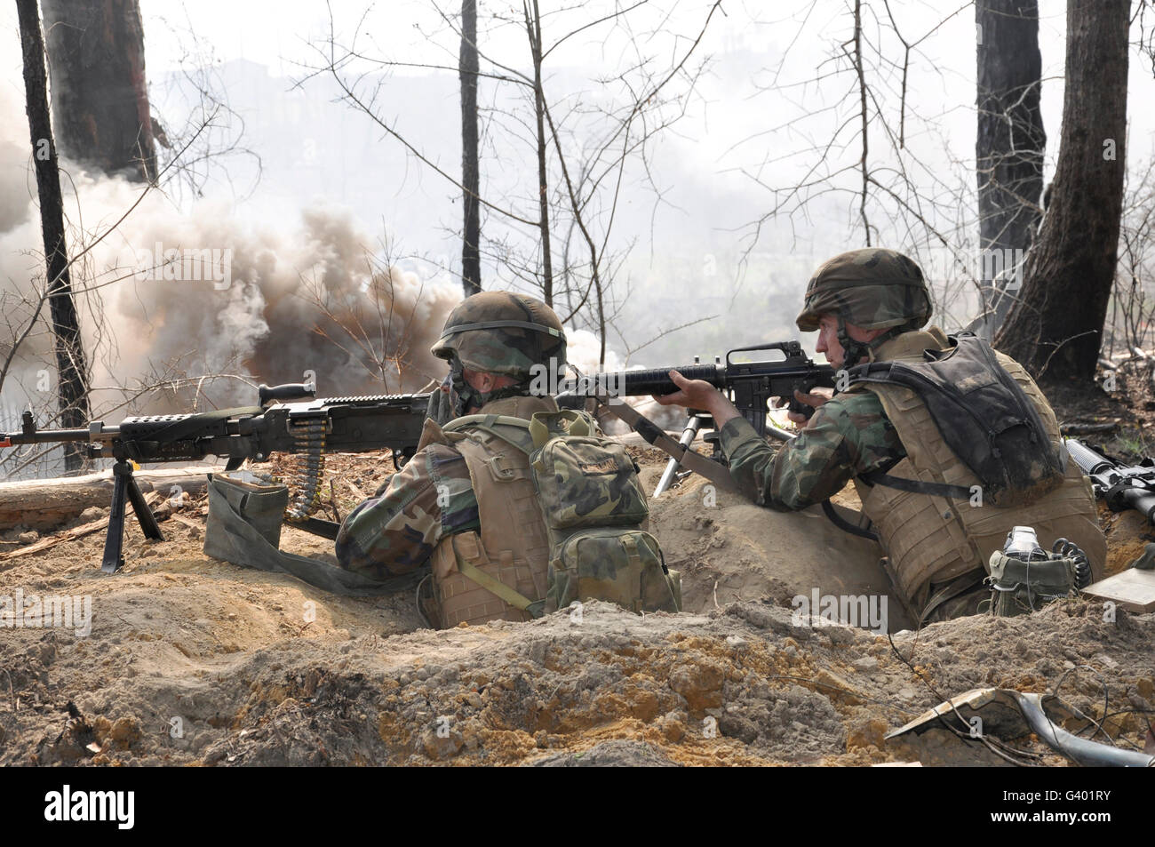 Soldiers fire their weapons from a fox hole on the defensive line Stock ...