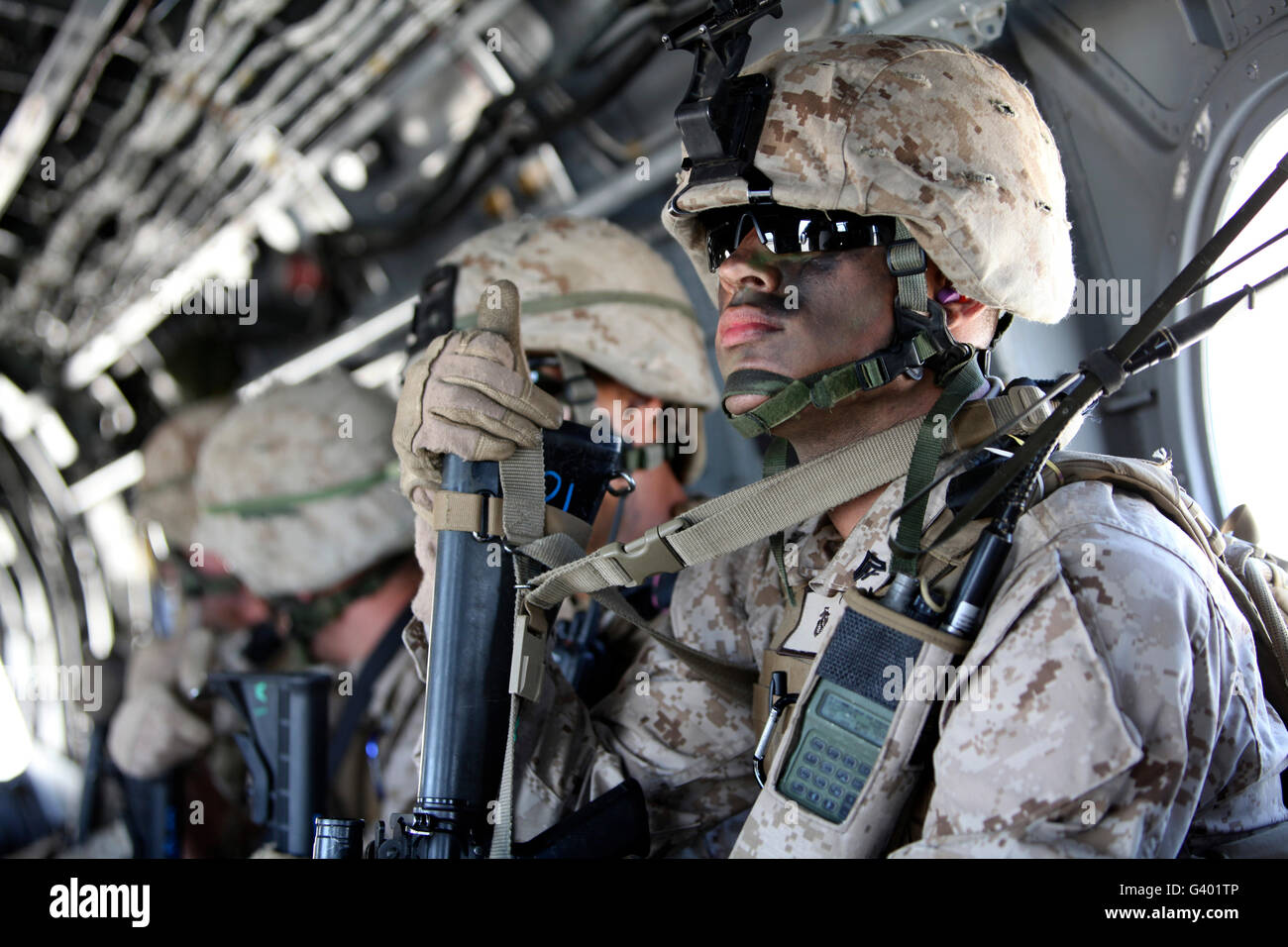 A soldier rides in a helicopter Stock Photo - Alamy