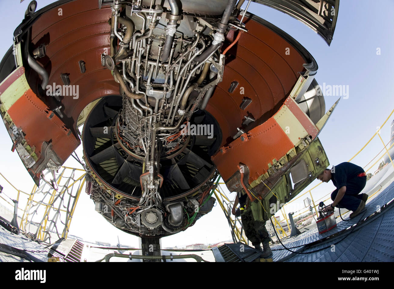 U.S. Air Force technician hydraulically opens the engine cowlings of a ...